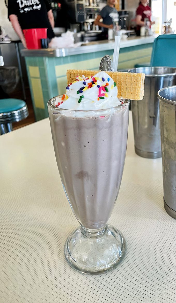 Milkshake masterpiece topped with whipped cream, sprinkles, and a wafer cookie. Not just a drink—it's dessert with a straw and zero regrets.