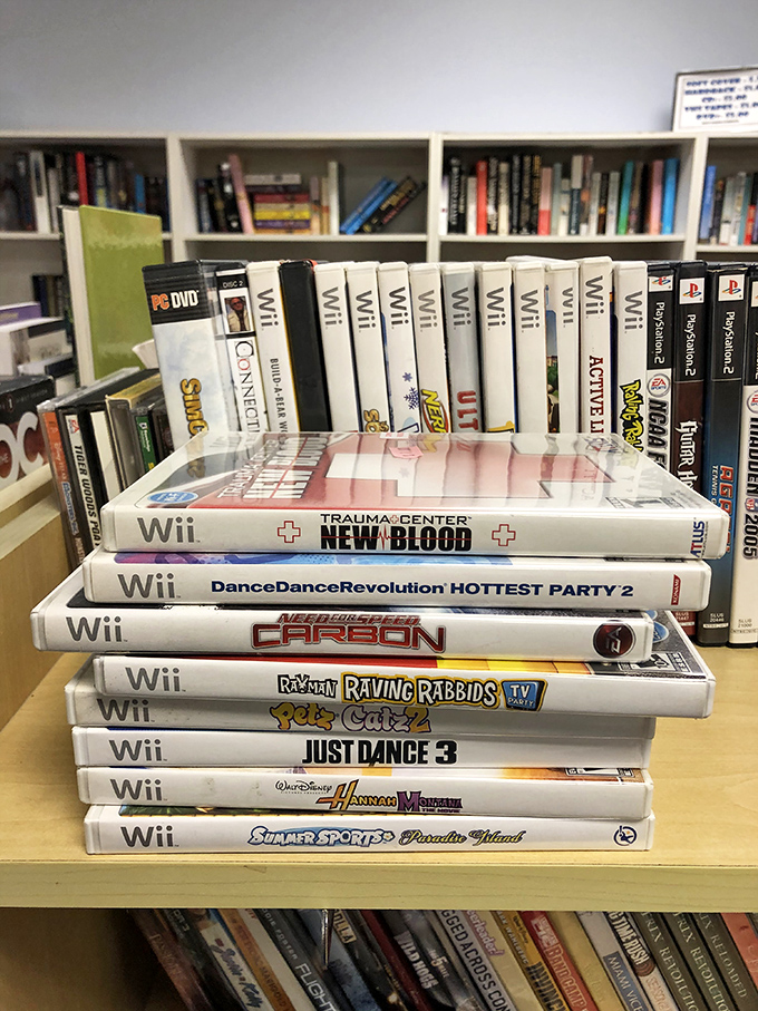 Nintendo Wii games stacked like a time capsule of family game nights. Just Dance 3 still remembers your questionable interpretation of the Macarena.