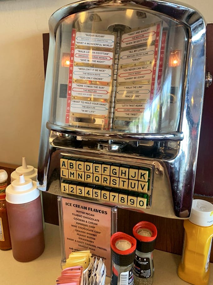 The tabletop jukebox—where five cents buys a soundtrack for your meal. From Beatles to Beach Boys, every bite deserves its own melody.