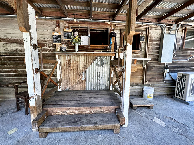 Order windows that feel like discovering a secret speakeasy – corrugated metal and weathered wood framing culinary treasures within.