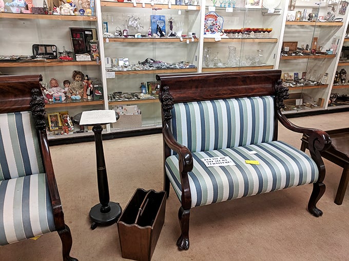 Victorian settees invite weary shoppers to rest while contemplating their next acquisition. The carved wooden details whisper tales of parlors past.