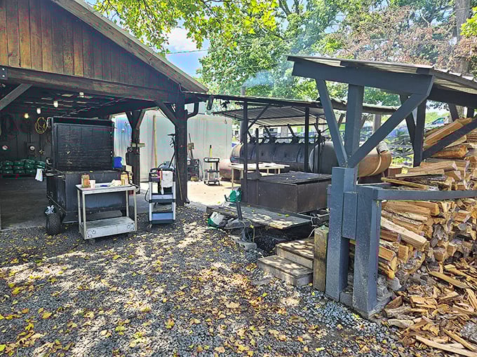 The outdoor pit area—barbecue's holy ground. Those stacks of wood aren't just fuel; they're the building blocks of flavor architecture.