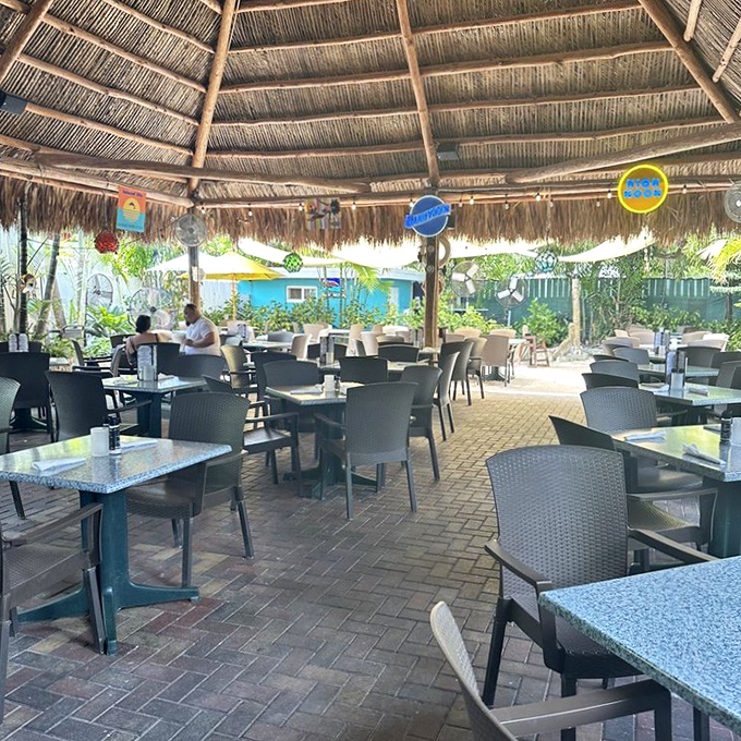Outdoor dining under thatched roofs transforms every meal into a tropical vacation, complete with ocean breezes and paradise.