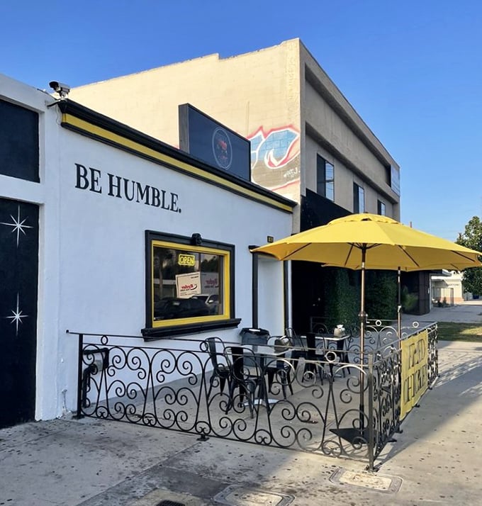 The sidewalk patio—where that yellow umbrella provides shade while you contemplate whether to order seconds before you've finished firsts.