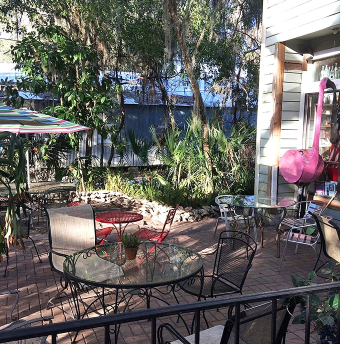 The outdoor seating area isn't just a place to eat—it's nature's dining room where Spanish moss serves as the chandelier.