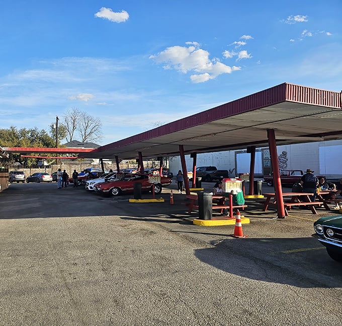 The covered parking area isn't just practical—it's sacred ground where classic cars and classic meals come together in perfect harmony.