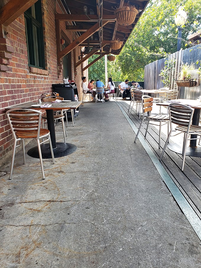 Outdoor dining under the shelter of history—brick walls that have seen decades of Raleigh life now witness your barbecue bliss.