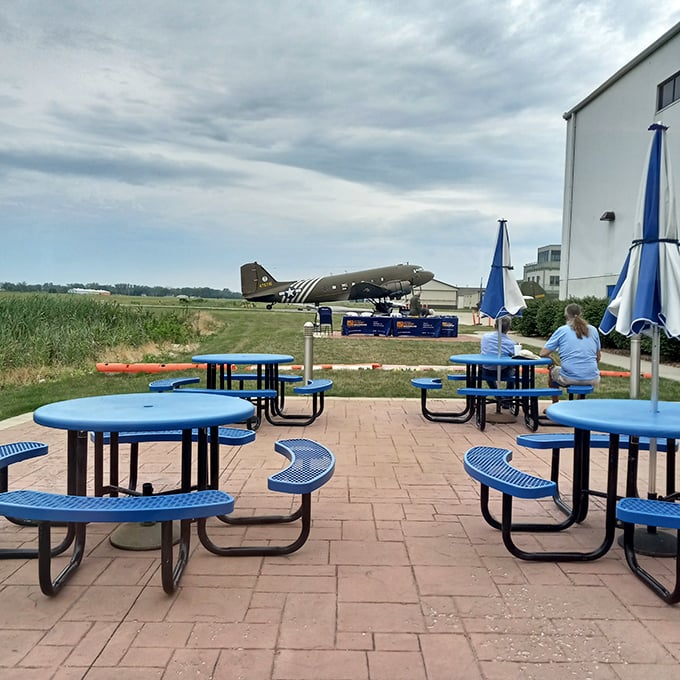 Outdoor seating with a view of actual vintage aircraft. Your pancakes come with a side of aviation history.