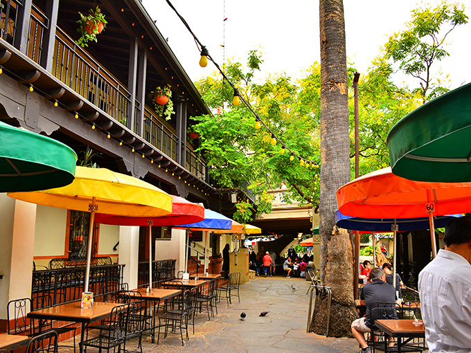 Dining under those rainbow umbrellas feels like you've discovered a secret garden where tacos and margaritas grow naturally.