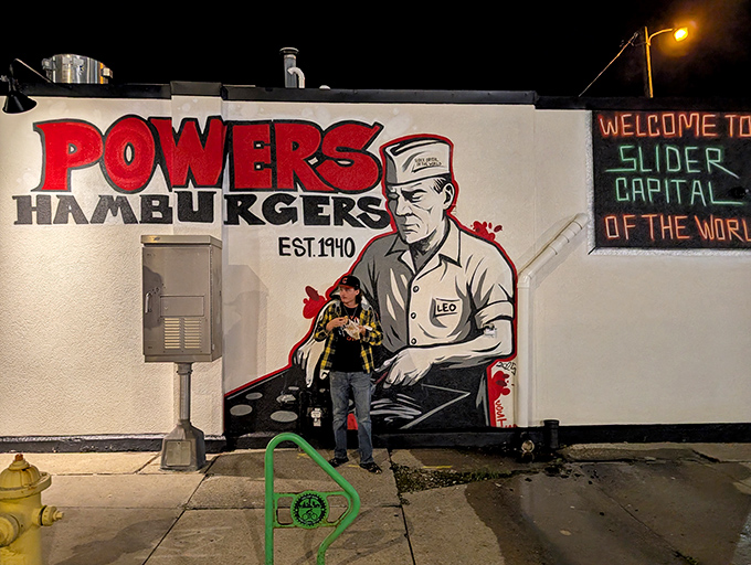 Night transforms Powers into a neon-lit beacon of burger hope. "Slider Capital of the World" isn't just a claim—it's a promise.