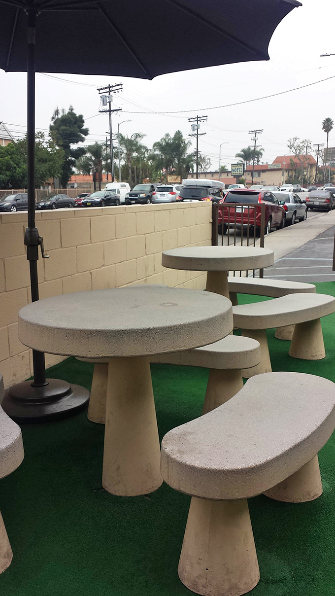 Outdoor concrete tables stand ready for those who can't wait to get home before diving into their BBQ treasures.