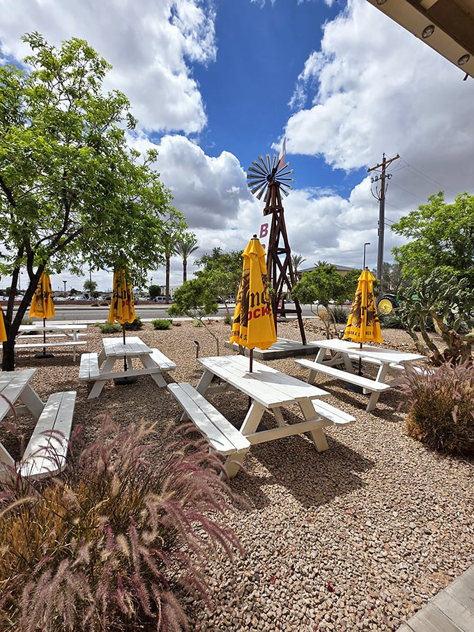 Desert landscaping meets BBQ paradise. White picnic tables under yellow umbrellas – Arizona's answer to the traditional Texas BBQ yard.