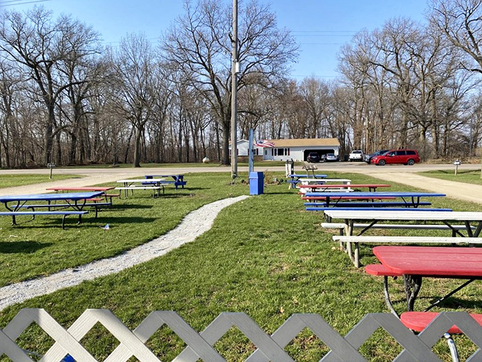 The outdoor dining room where Michigan summers shine brightest – picnic tables waiting for the next round of burger enthusiasts.