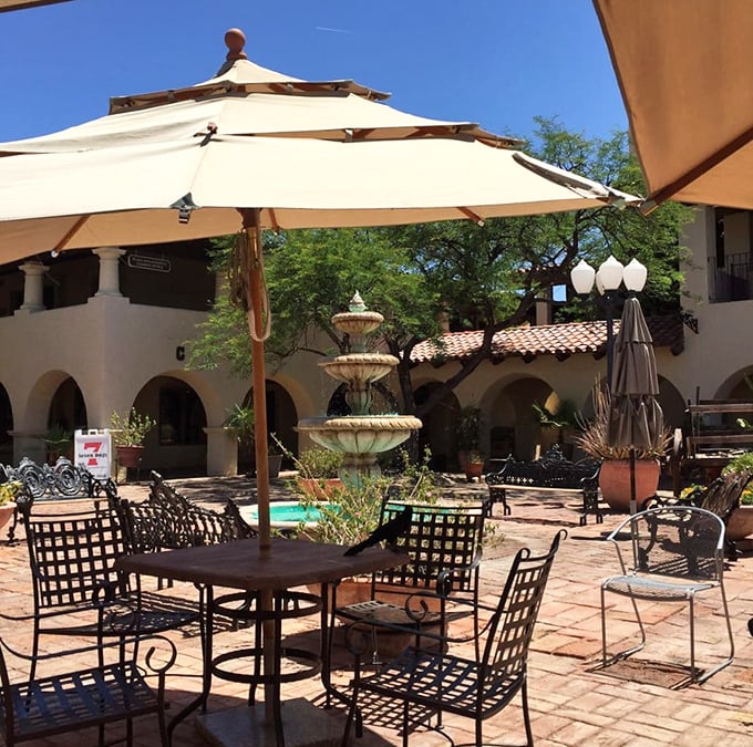 Desert dining perfected—umbrella-shaded tables in a courtyard where fountain sounds provide the soundtrack to your outdoor feast.