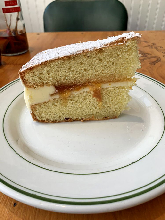 This Victoria sponge with custard filling isn't just cake—it's what angels eat when no one's looking. Worth every calorie.