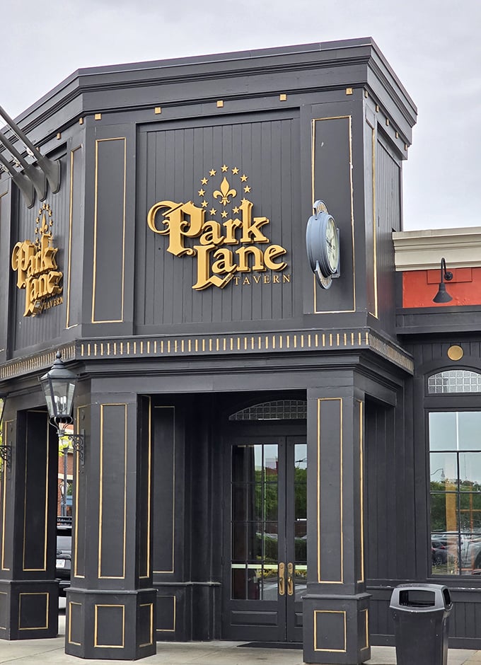 Park Lane Tavern's elegant façade with gold accents and dramatic black exterior hints at the European-inspired experience waiting inside.