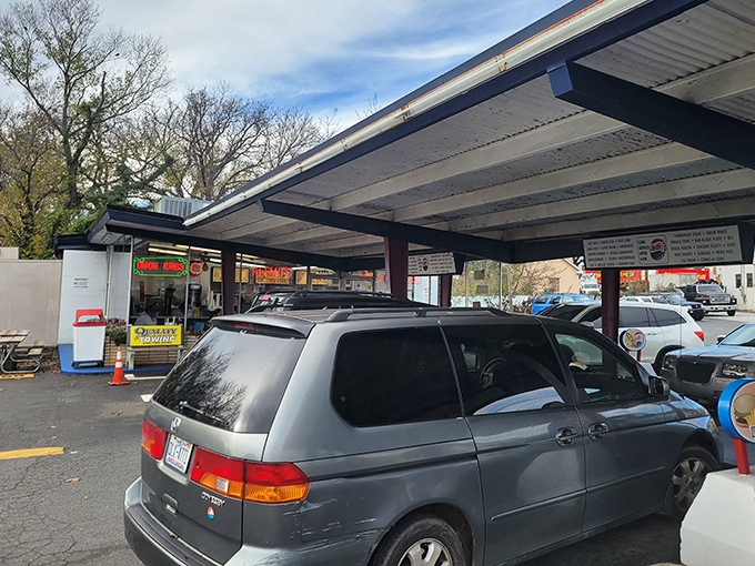 The drive-thru experience—where convenience meets tradition. Car windows down, the scent of grilled hot dogs wafting through the air, life is momentarily perfect.