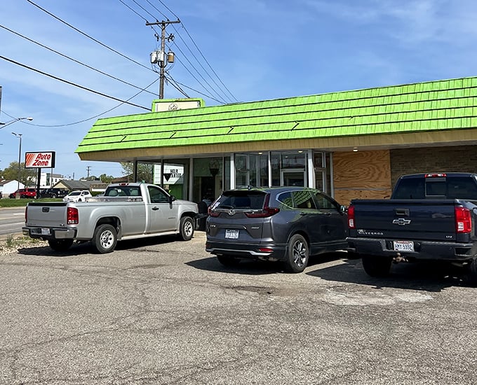 The parking lot—where vehicles of all makes and models find democracy in their shared mission: donut acquisition.