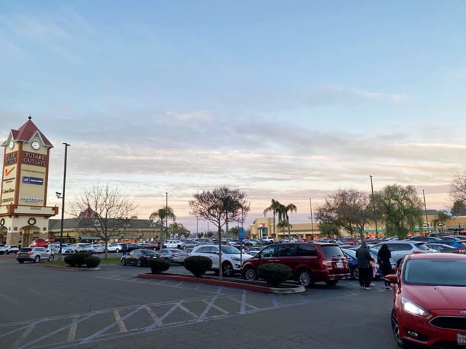 The parking lot at dusk—where California sunsets compete with the glow of satisfaction from shoppers clutching bags of bargains.