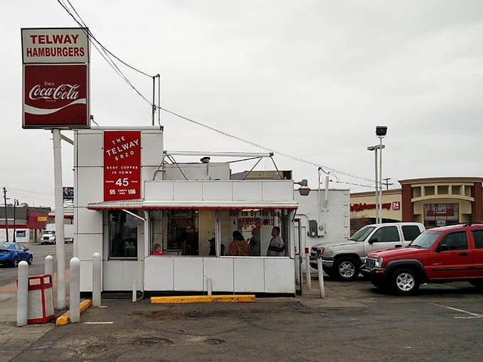 The humble exterior belies the culinary treasures within. Cars in the lot represent the great equalizer that is exceptional diner food.