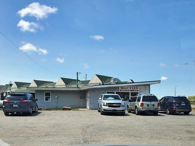 The gravel parking lot fills with vehicles from all walks of life—pickup trucks to family sedans—united by the universal language of great burgers.