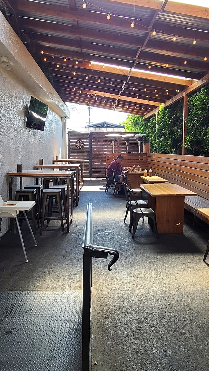 The patio at Moo's offers al fresco dining under string lights—because barbecue tastes even better with a side of fresh air.