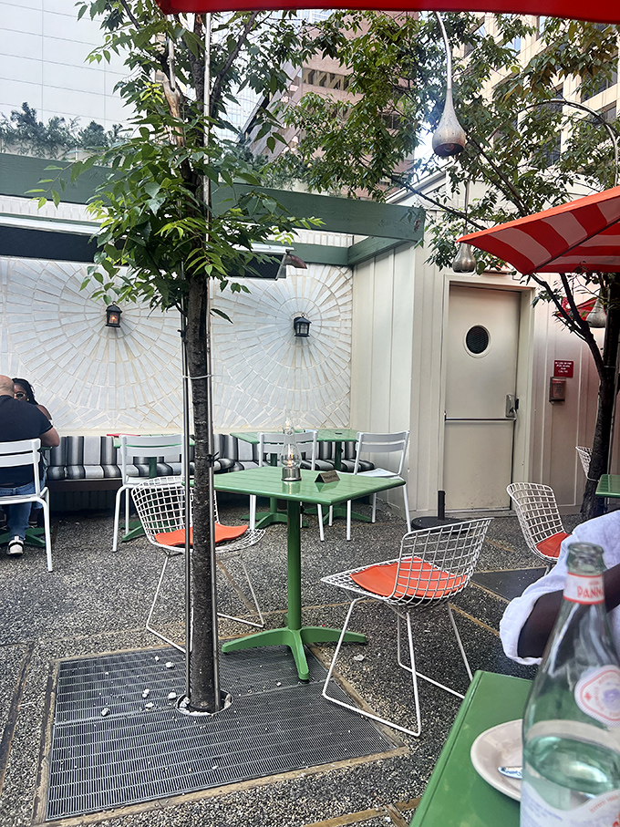 The outdoor patio offers an urban oasis with minimalist furniture, strategic greenery, and the perfect escape from Center City's hustle.