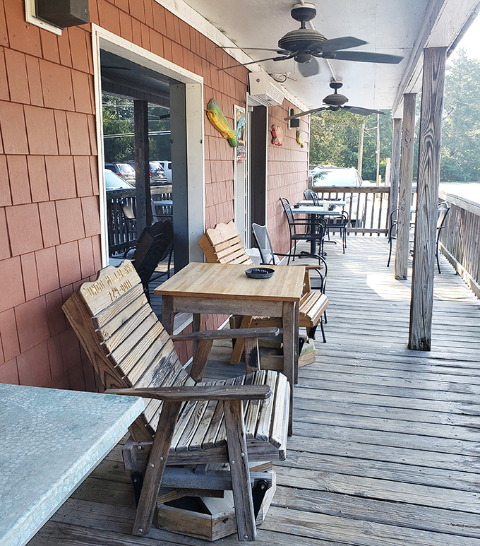 The weathered porch offers respite between seafood courses, where salt air enhances the anticipation of what's to come.