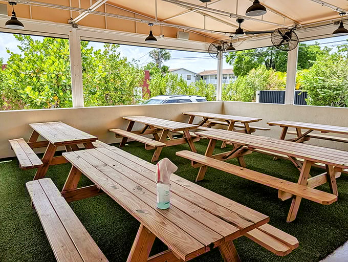 Covered patio dining with artificial turf creates an outdoor oasis perfect for Florida's year-round weather.