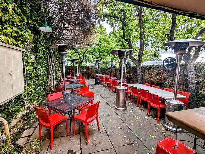 The patio's red chairs pop like exclamation points in a love letter to al fresco dining.