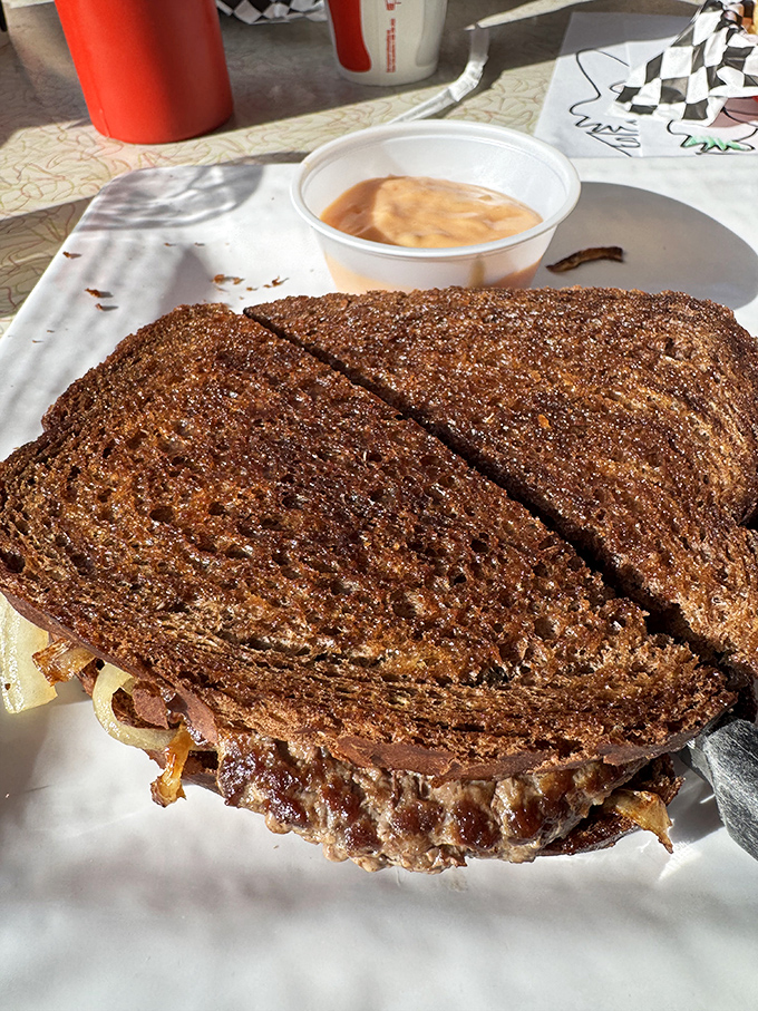 The patty melt—that beautiful marriage of burger and grilled cheese—arrives with a side of nostalgia that no trendy restaurant could replicate.