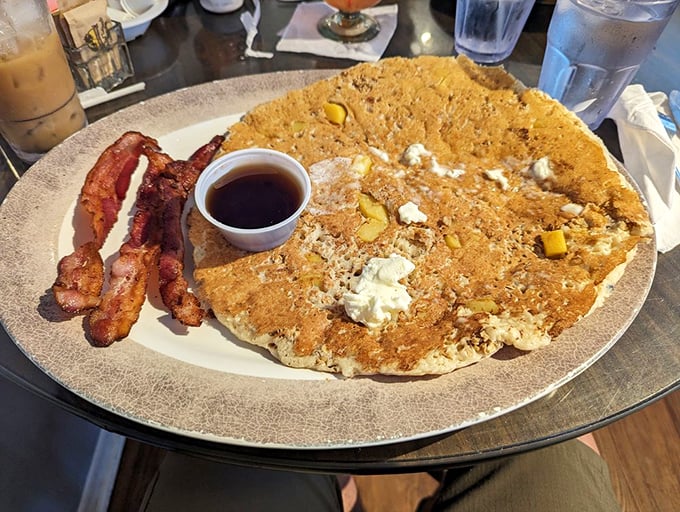 A pancake the size of a frisbee, studded with peaches and paired with perfectly crisp bacon. Breakfast doesn't get more impressive than this.