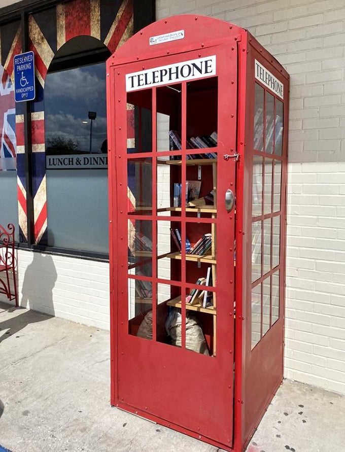 The iconic red telephone booth stands guard outside—a perfect photo op before diving into your fish and chips feast.