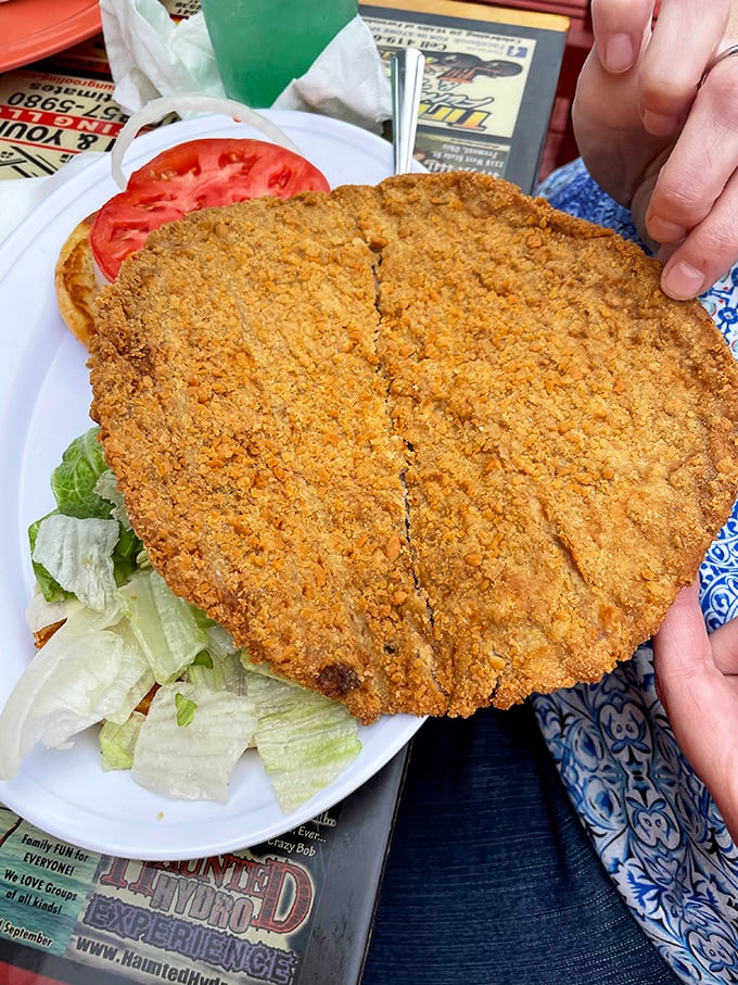 The breaded pork tenderloin stretches well beyond its bun boundaries – a Midwest tradition that asks the important question: "Why should bread get all the attention?"