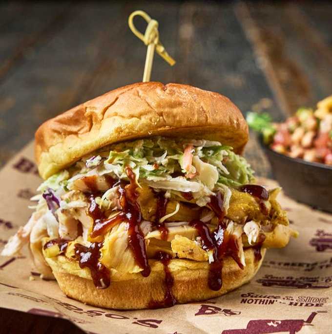 The pulled chicken sandwich topped with slaw brings the perfect balance of smoke, sauce, and crunch—proof that barbecue isn't just about beef and pork.