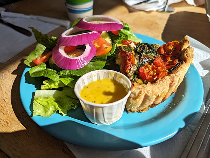 Quiche that looks like it's been taking confidence lessons. That vibrant side salad isn't just garnish—it's the quiche's equally important dance partner.