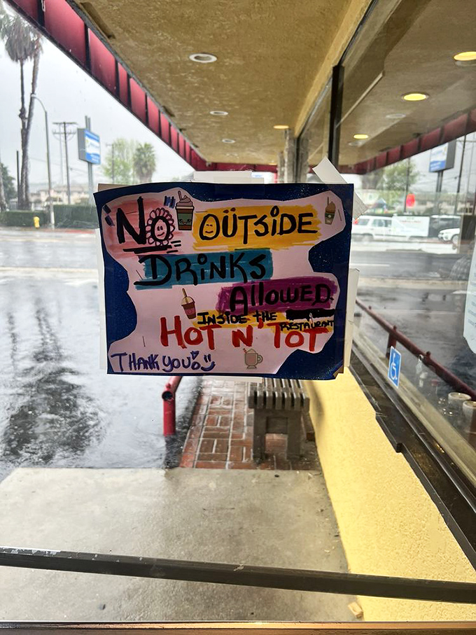 House rules delivered with artistic flair. The "No Outside Drinks" policy seems entirely reasonable when their coffee is this good.