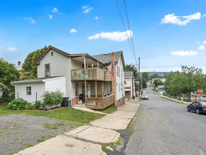 Modest homes with American flags and front porches represent Tamaqua's greatest asset – housing that remains within reach of actual retirement budgets.