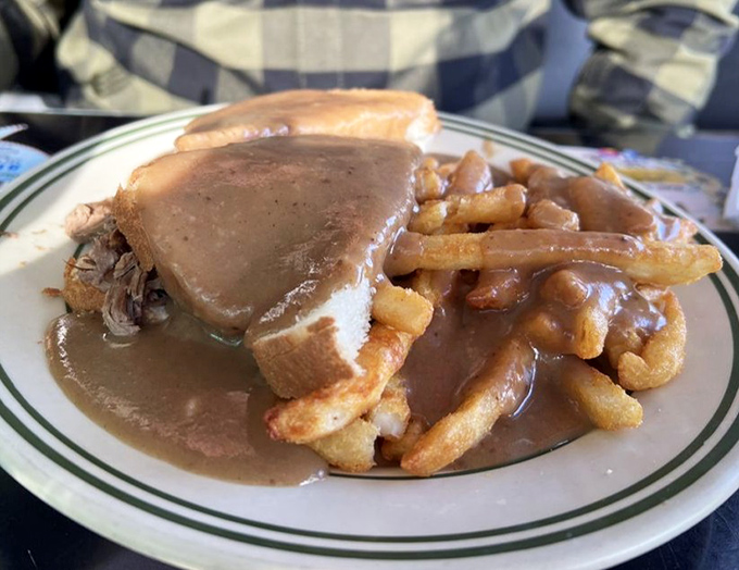 Hot roast beef sandwich swimming in gravy—comfort food so perfect it should come with a warning: "May induce involuntary food coma and feelings of contentment."