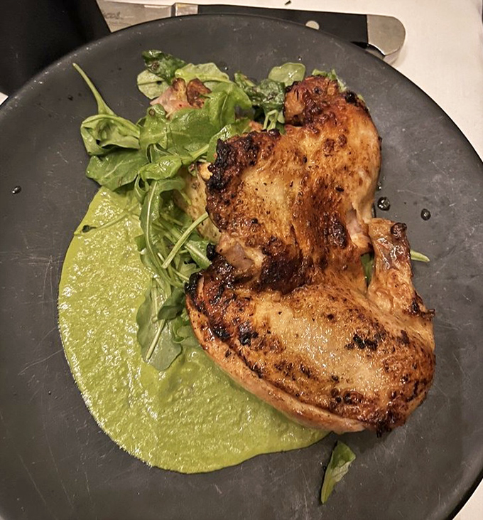 Perfectly roasted chicken resting on vibrant green sauce. Proof that sometimes the humble bird can outshine its beefy counterparts.