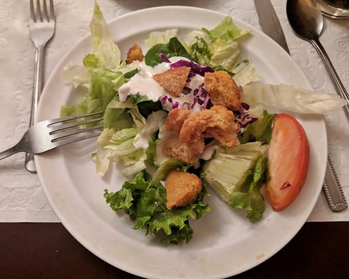 Even the salad gets the star treatment—crisp greens playing host to a gathering of croutons that clearly received their VIP invitations.