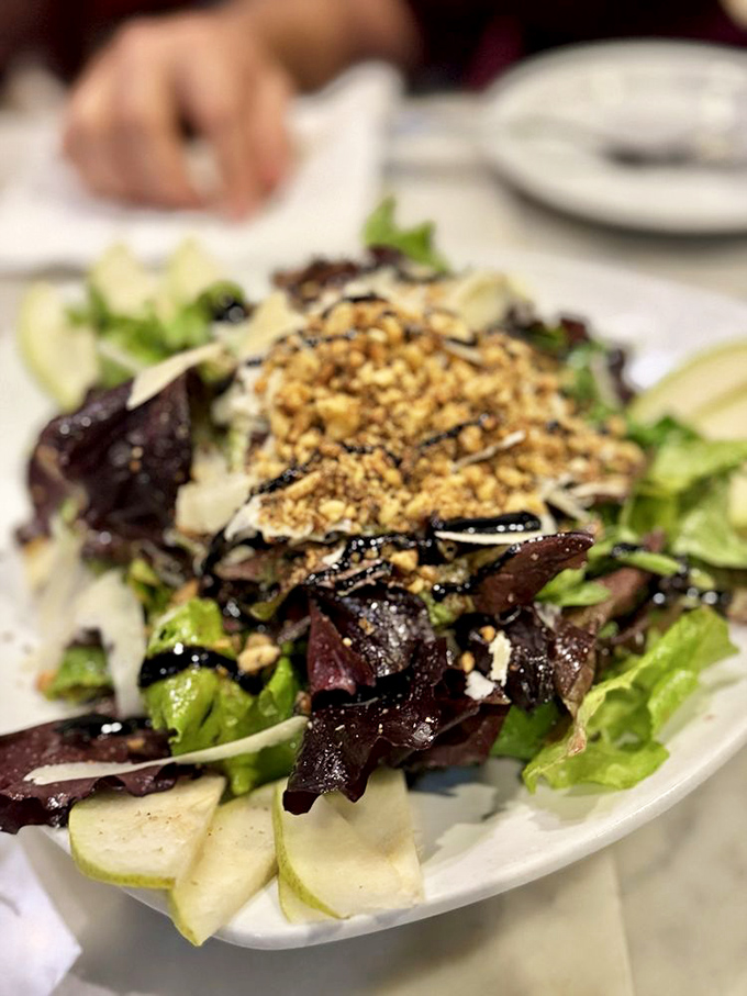This salad isn't just a prelude to pizza—it's worthy of its own standing ovation. Crisp greens, crunchy nuts, and shaved cheese in perfect harmony.
