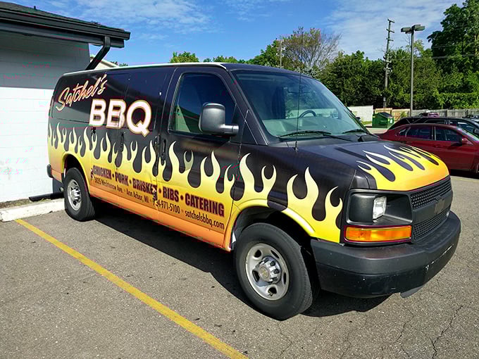 The Batmobile of barbecue—Satchel's catering van announces its arrival with flames that promise smoky delights within.