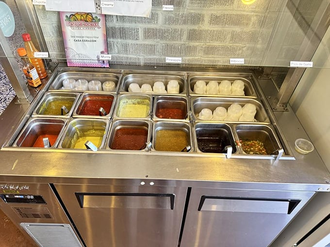 The salsa station—a colorful array of liquid treasures where heat-seekers and flavor-chasers alike can customize their perfect bite.