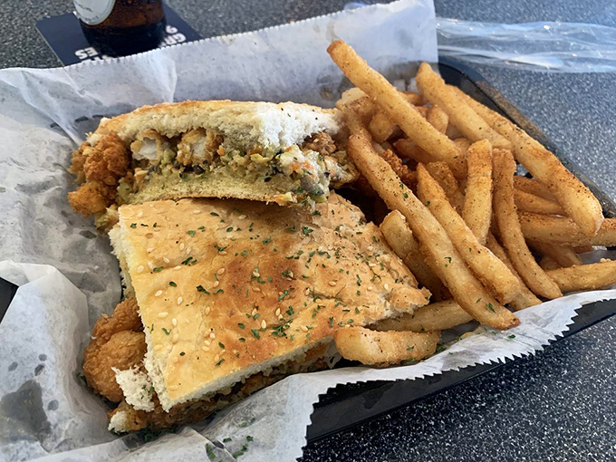 This po-boy isn't just a sandwich; it's an engineering marvel of crispy seafood, soft bread, and the reason napkins were invented. 