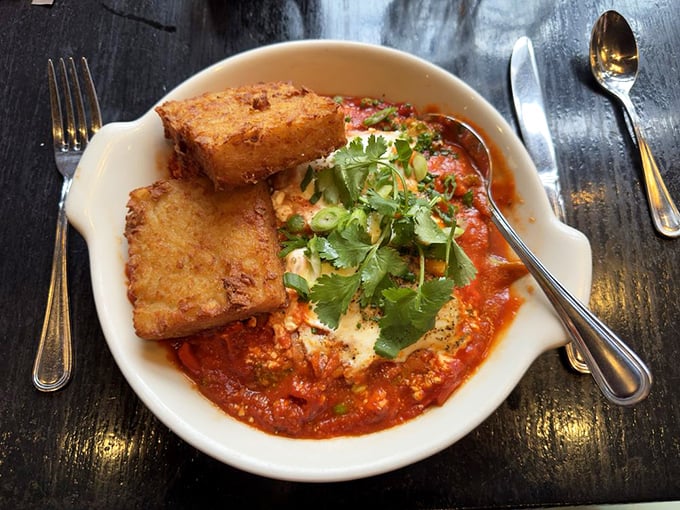 Shakshuka that makes eggs reconsider their life choices, nestled in a tomato bath that's part spa day, part flavor explosion.