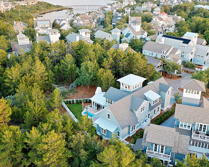 Pastel-colored homes nestle among pine forests, proving that retirement communities can offer both natural beauty and neighborly connections without Manhattan prices.