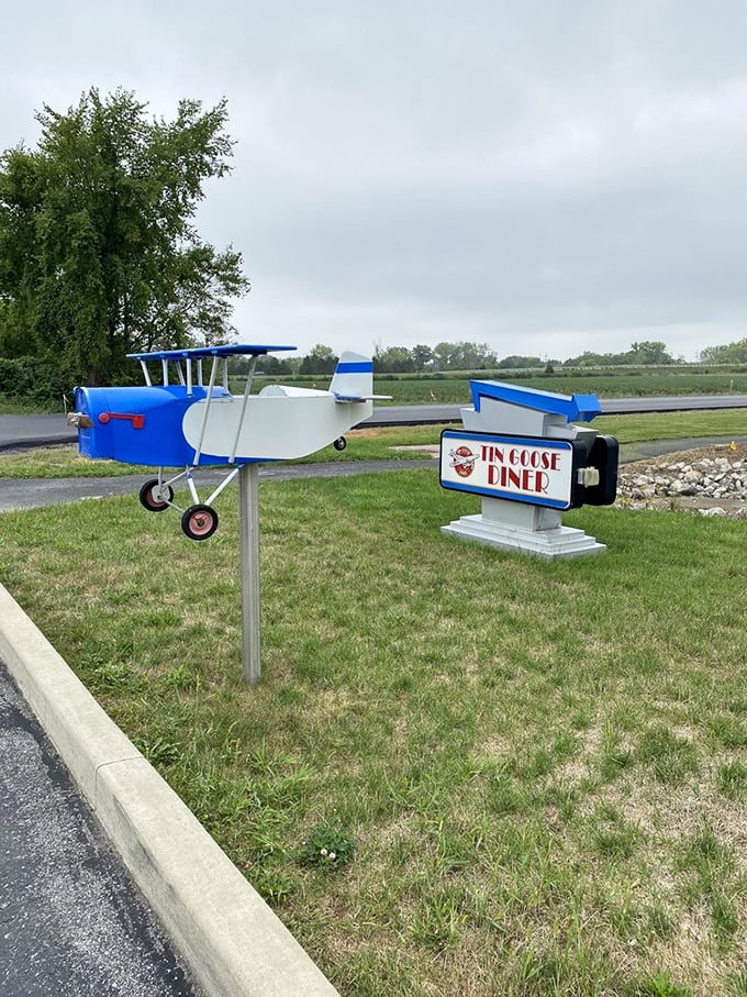 Not all who wander are lost—especially if they follow this sign. The miniature airplane points the way to pancake paradise.