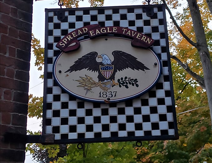 The tavern's iconic sign announces its 1837 heritage with patriotic flair. That eagle isn't just spreading its wings – it's inviting you inside.