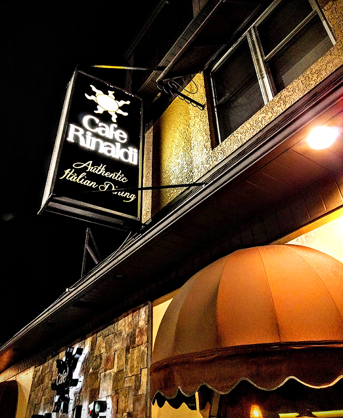 The illuminated sign doesn't just announce a restaurant—it signals the presence of "Authentic Italian Dining" that generations of locals have treasured.
